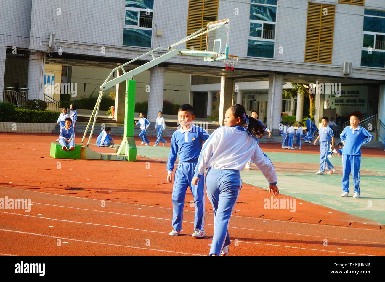 The pupils are having PE lessons on the school playground, and the ...