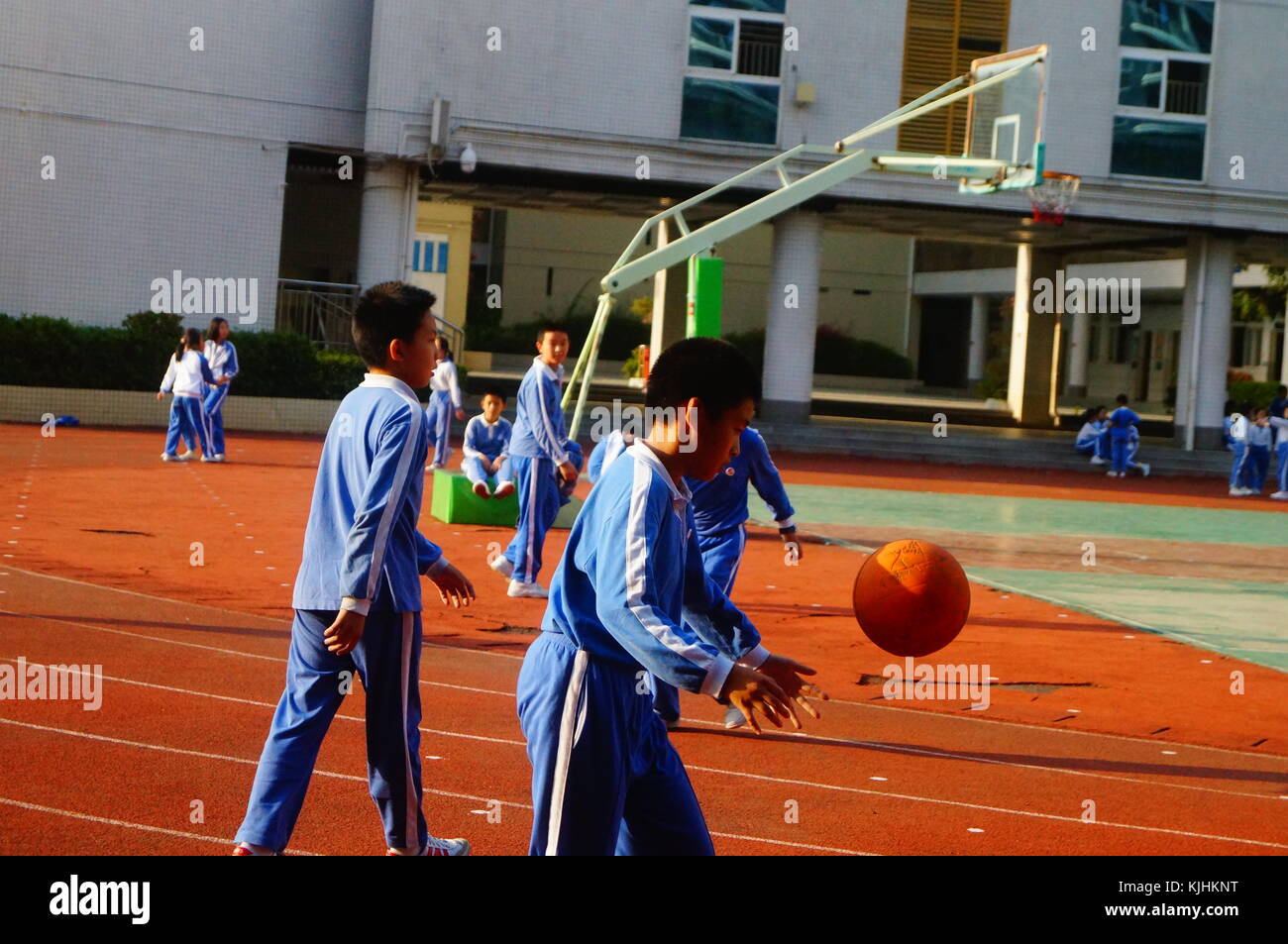 The pupils are having PE lessons on the school playground, and the ...