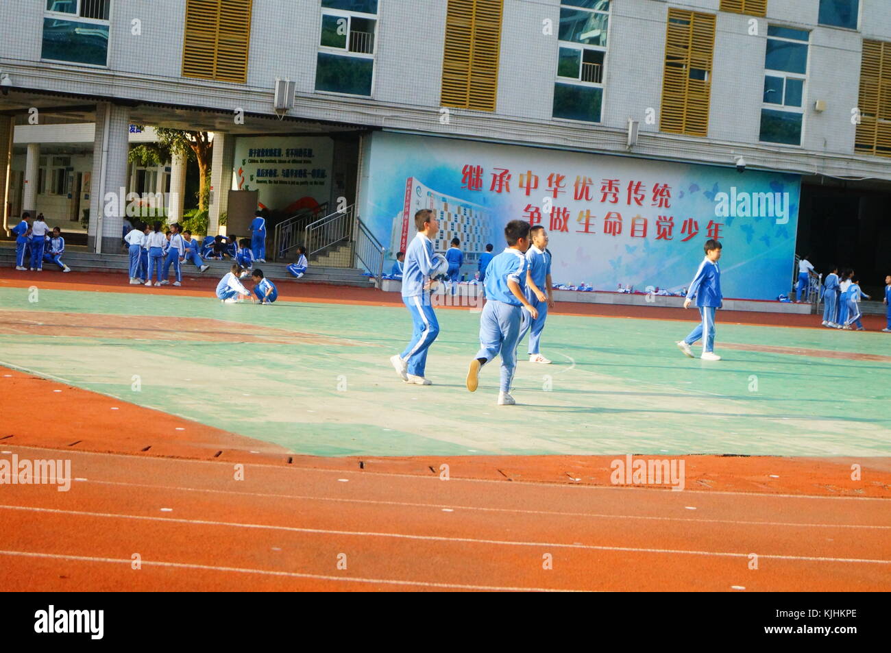 The pupils are having PE lessons on the school playground, and the ...