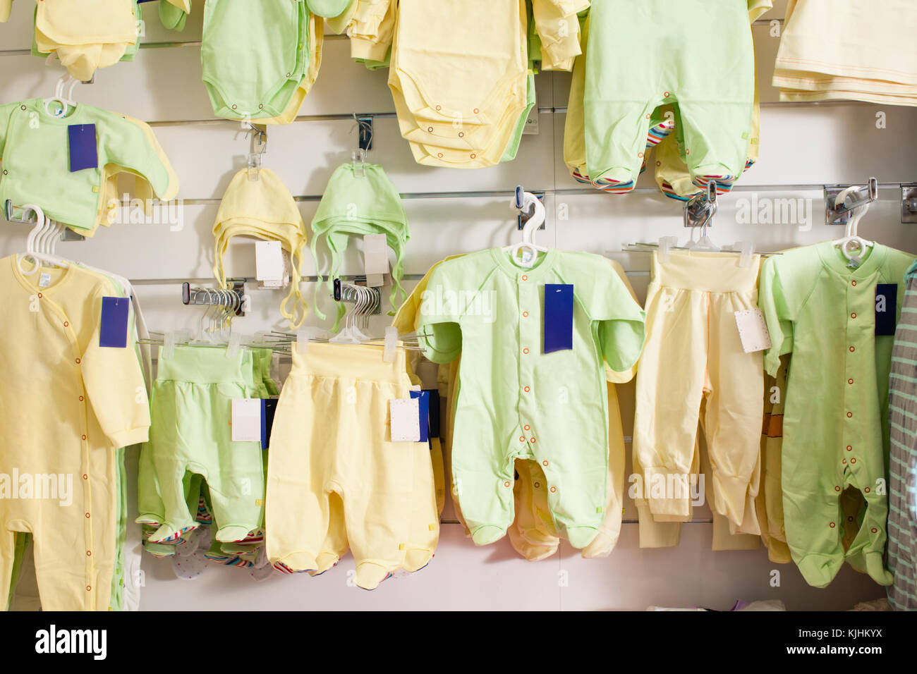 Shelf with baby clothes in a boutique Stock Photo - Alamy