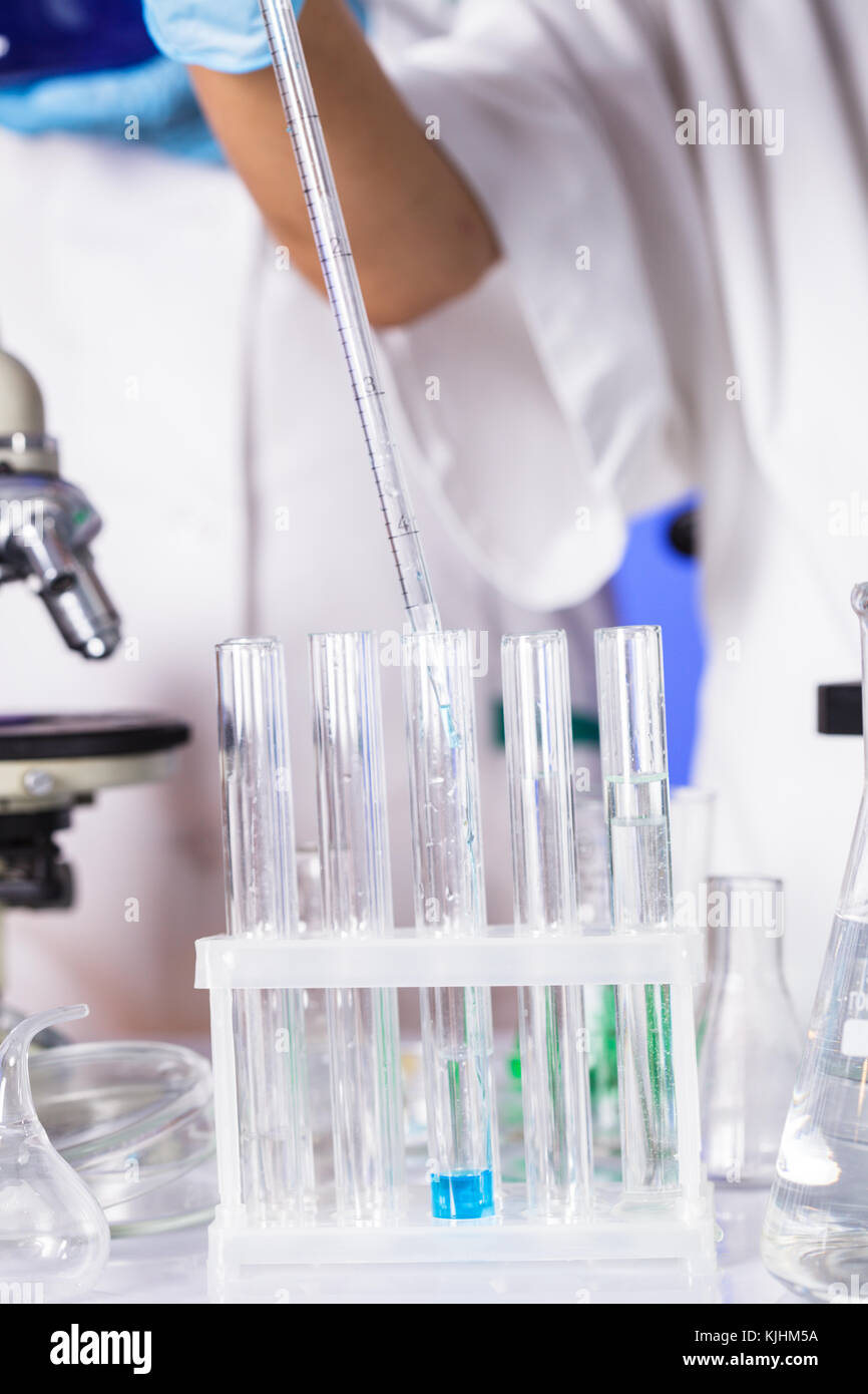 The blue drop from pipette in laboratory tubes Stock Photo - Alamy