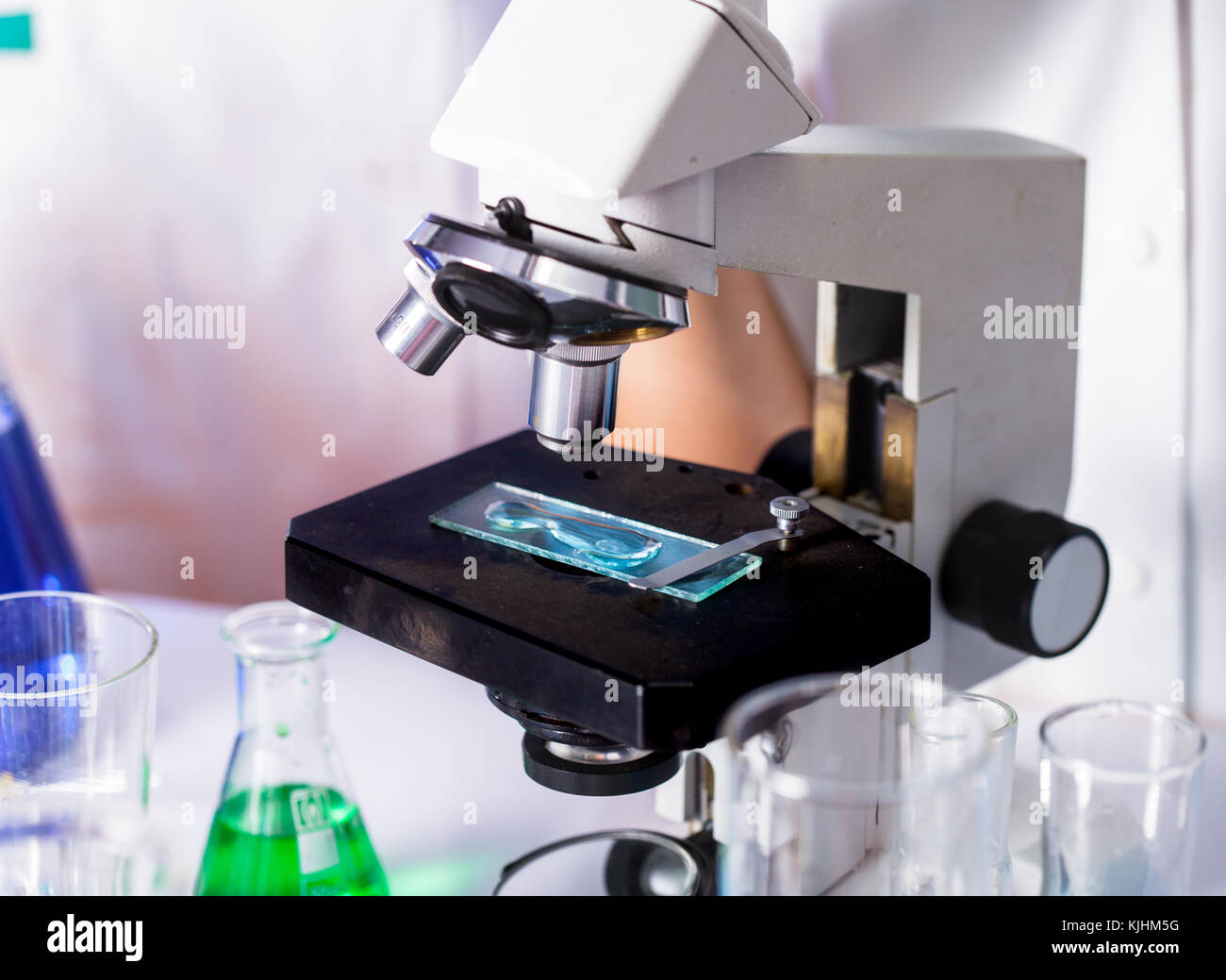 Young scientist look to the microscope ocular in the chemical ...