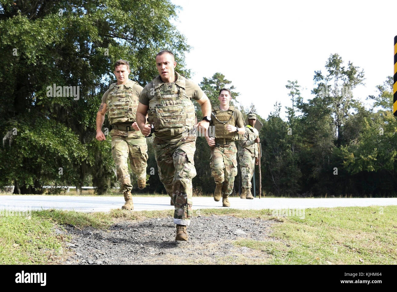 Soldiers with the 92nd Engineer Battalion, run toward the finish line ...