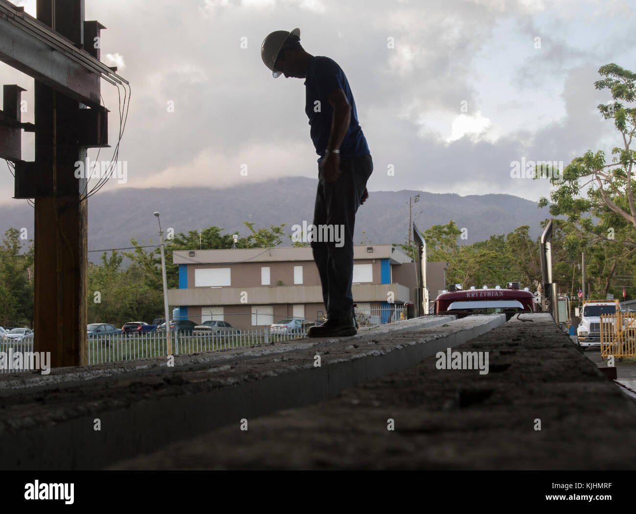 SAN JUAN, Puerto Rico – A worker inspects utility poles that have been ...