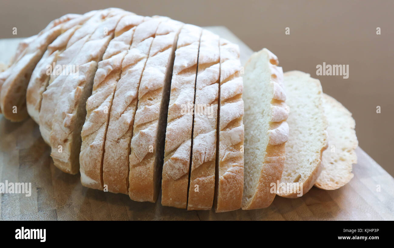 sliced baguette or sliced bread on the block Stock Photo - Alamy