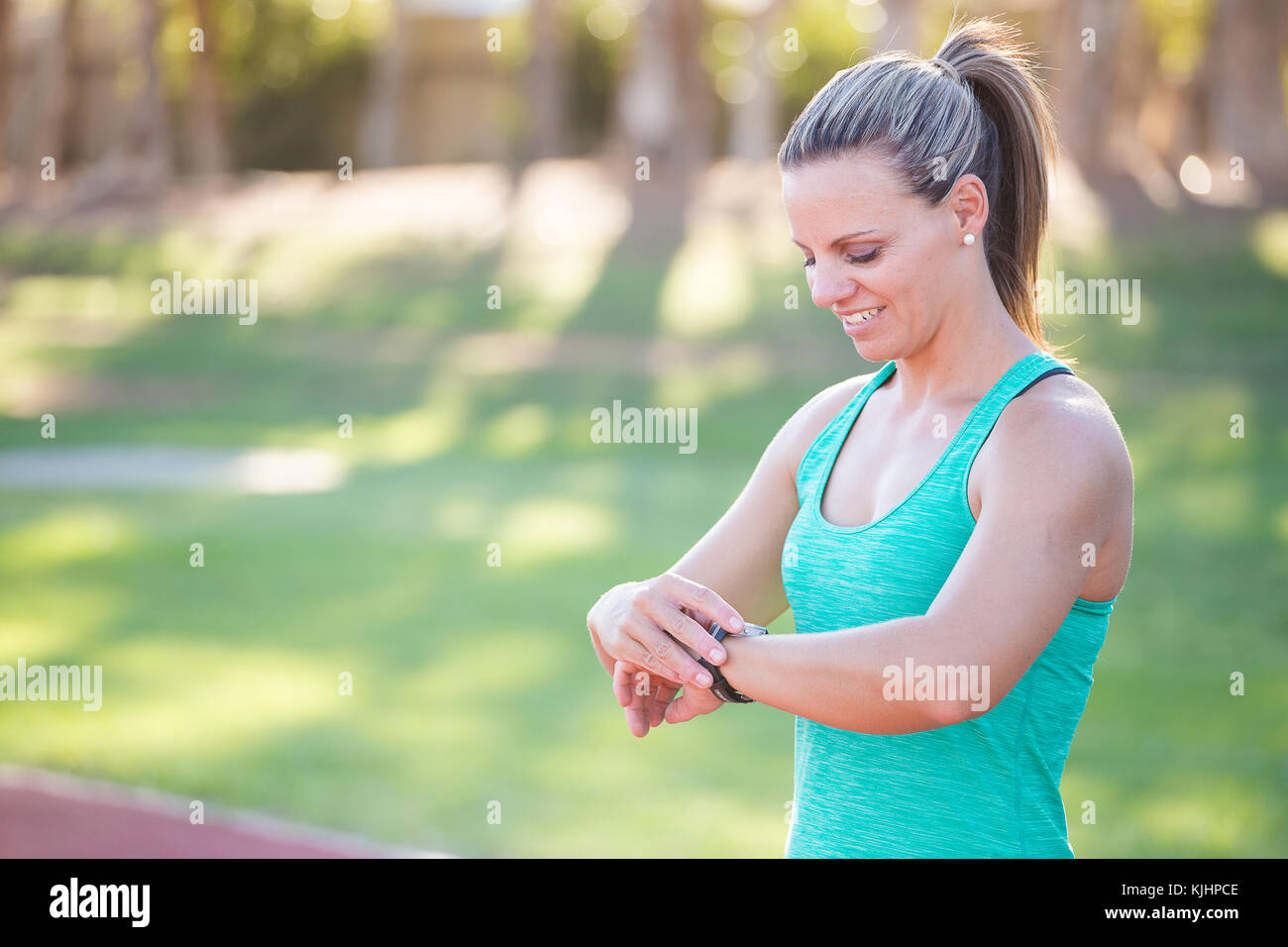 Close up wide angle view of a female sprinter athlete getting ready to ...