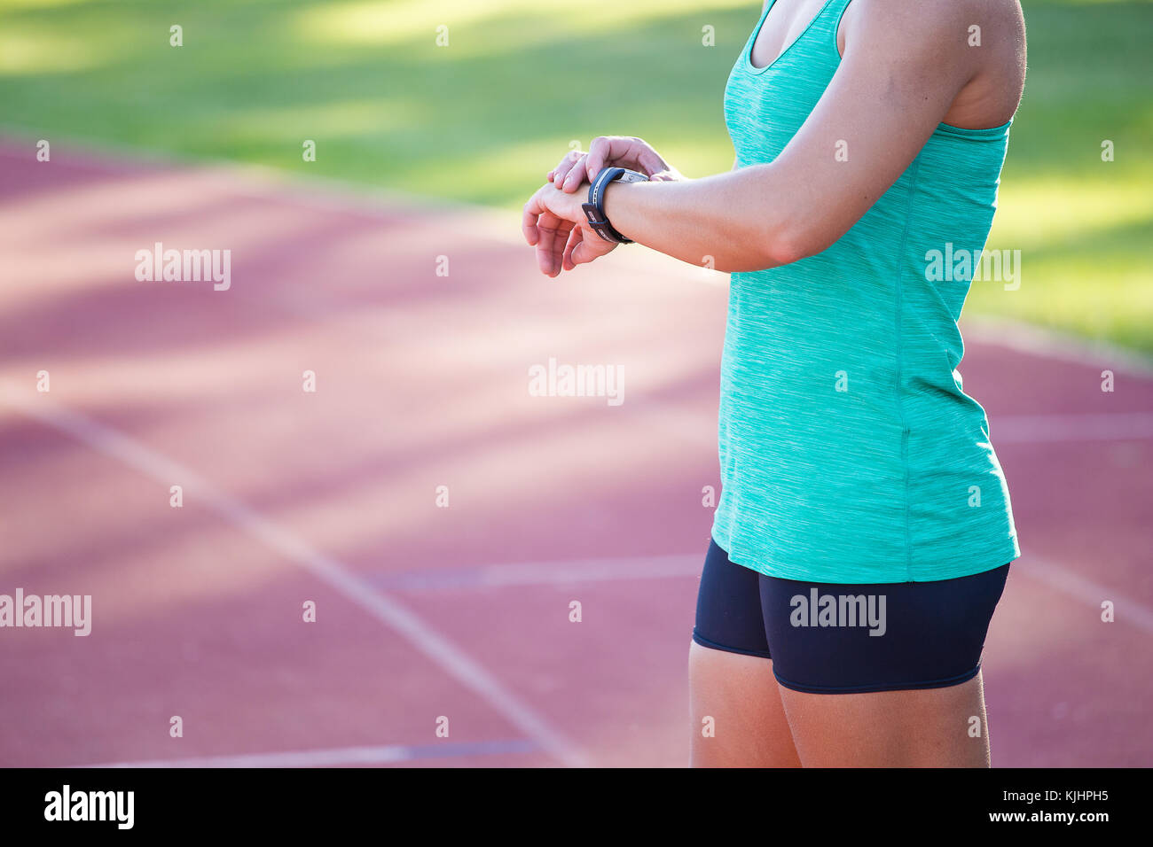 Close up wide angle view of a female sprinter athlete getting ready to ...
