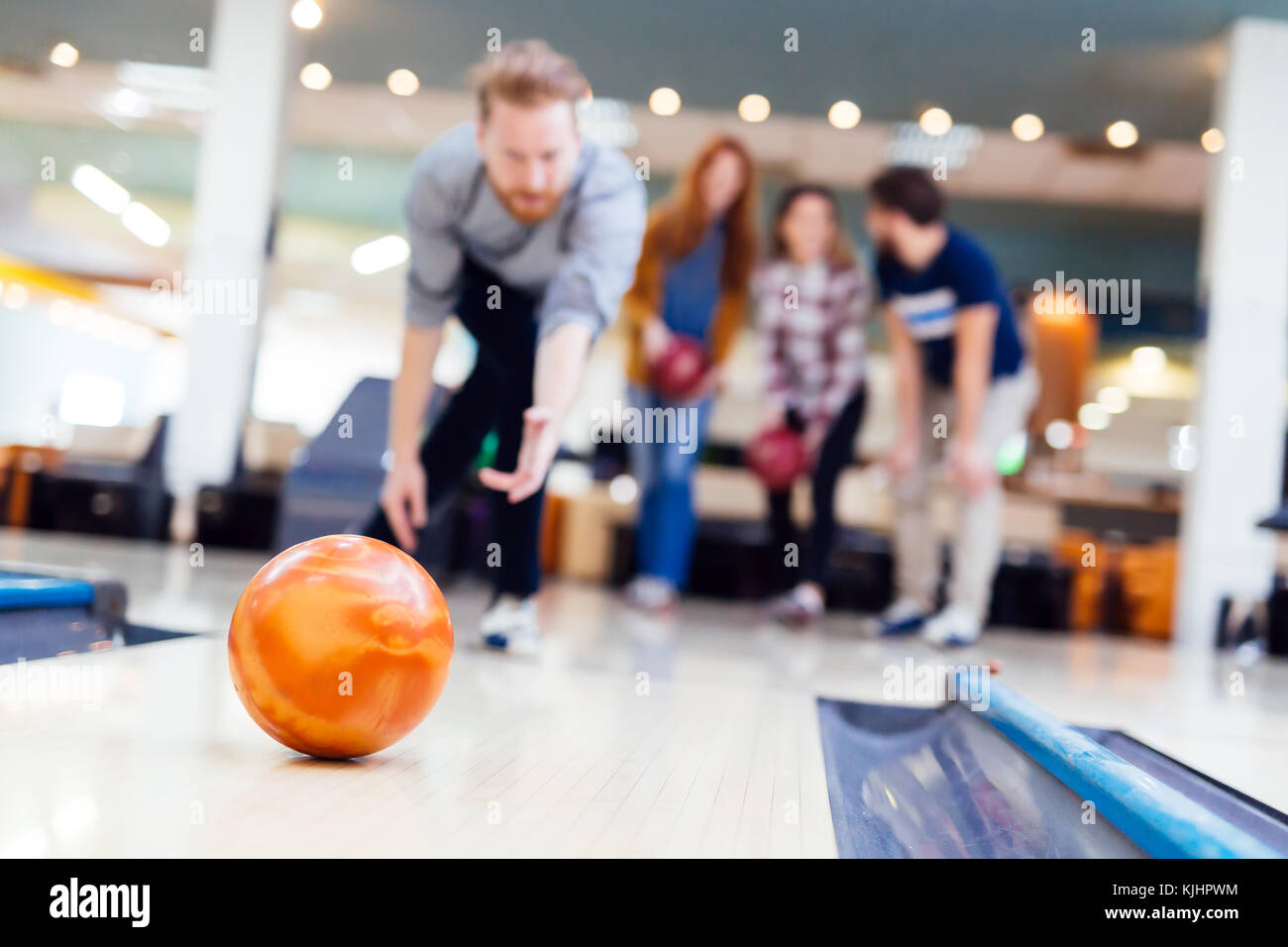 Friends bowling at club Stock Photo - Alamy