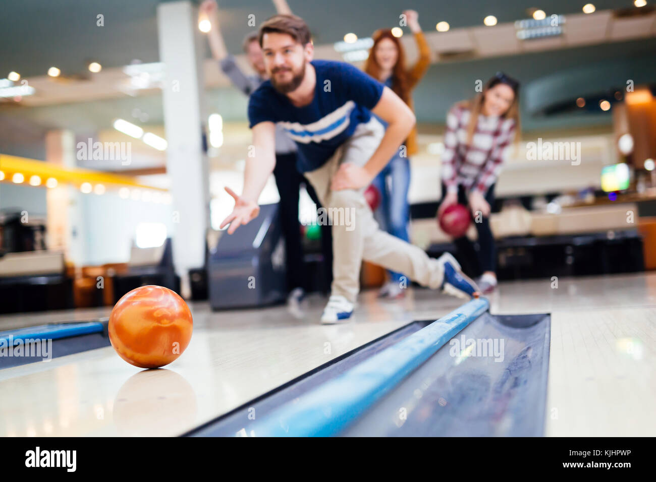 Friends having fun while bowling Stock Photo - Alamy