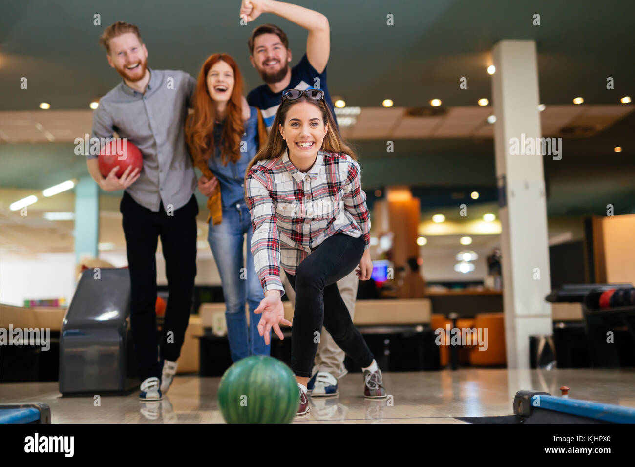 Friends bowling at club Stock Photo - Alamy