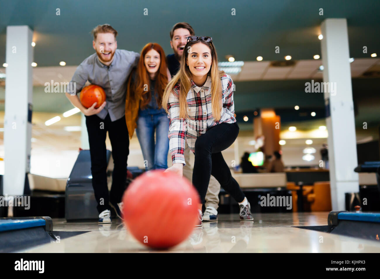 Friends having fun while bowling Stock Photo - Alamy