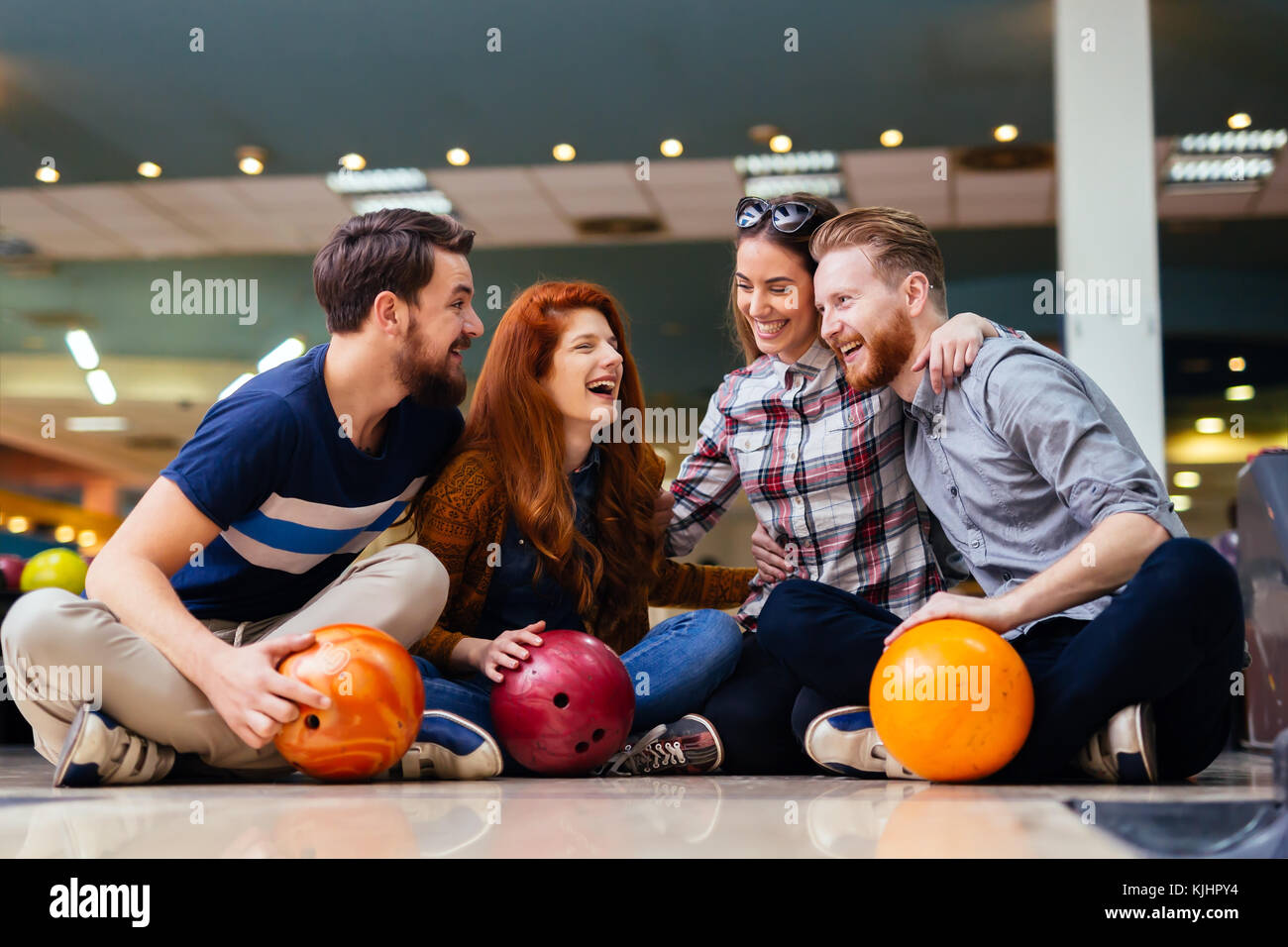 Friends having fun while bowling Stock Photo - Alamy