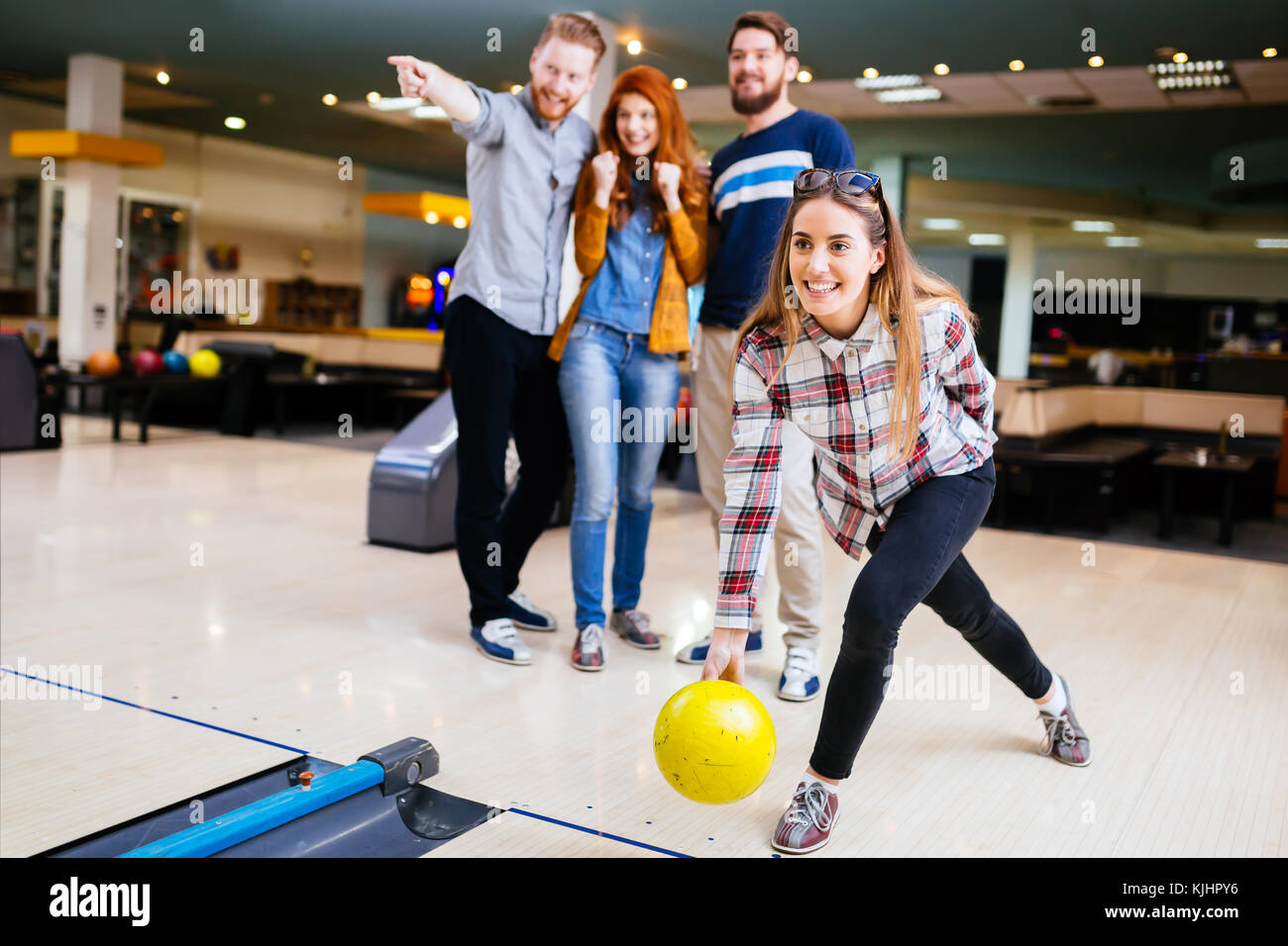 Competitve people enjoying bowling Stock Photo - Alamy