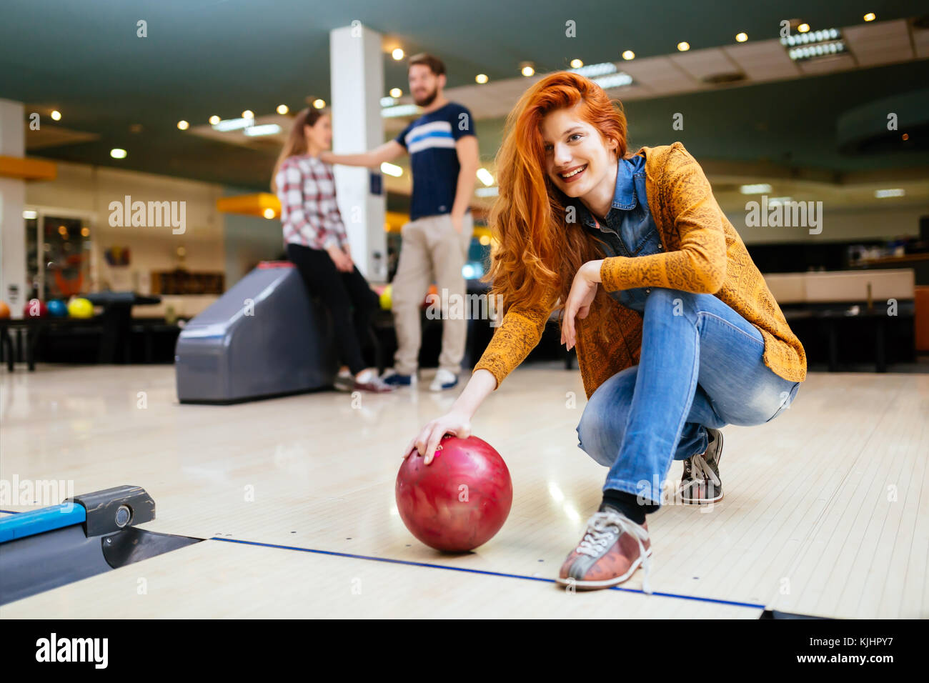Competitve people enjoying bowling Stock Photo - Alamy