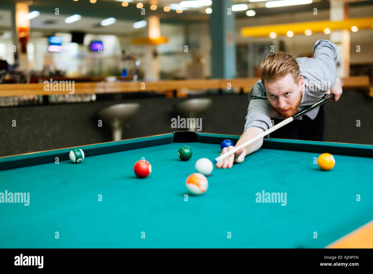 Handsome man aiming at ball Stock Photo - Alamy