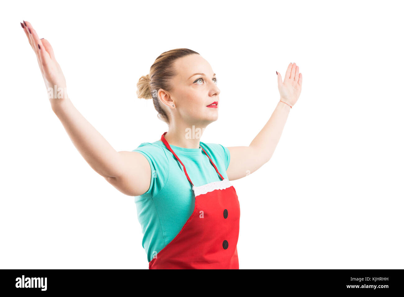 Woman wearing red apron rising lifting both hands and looking up ...