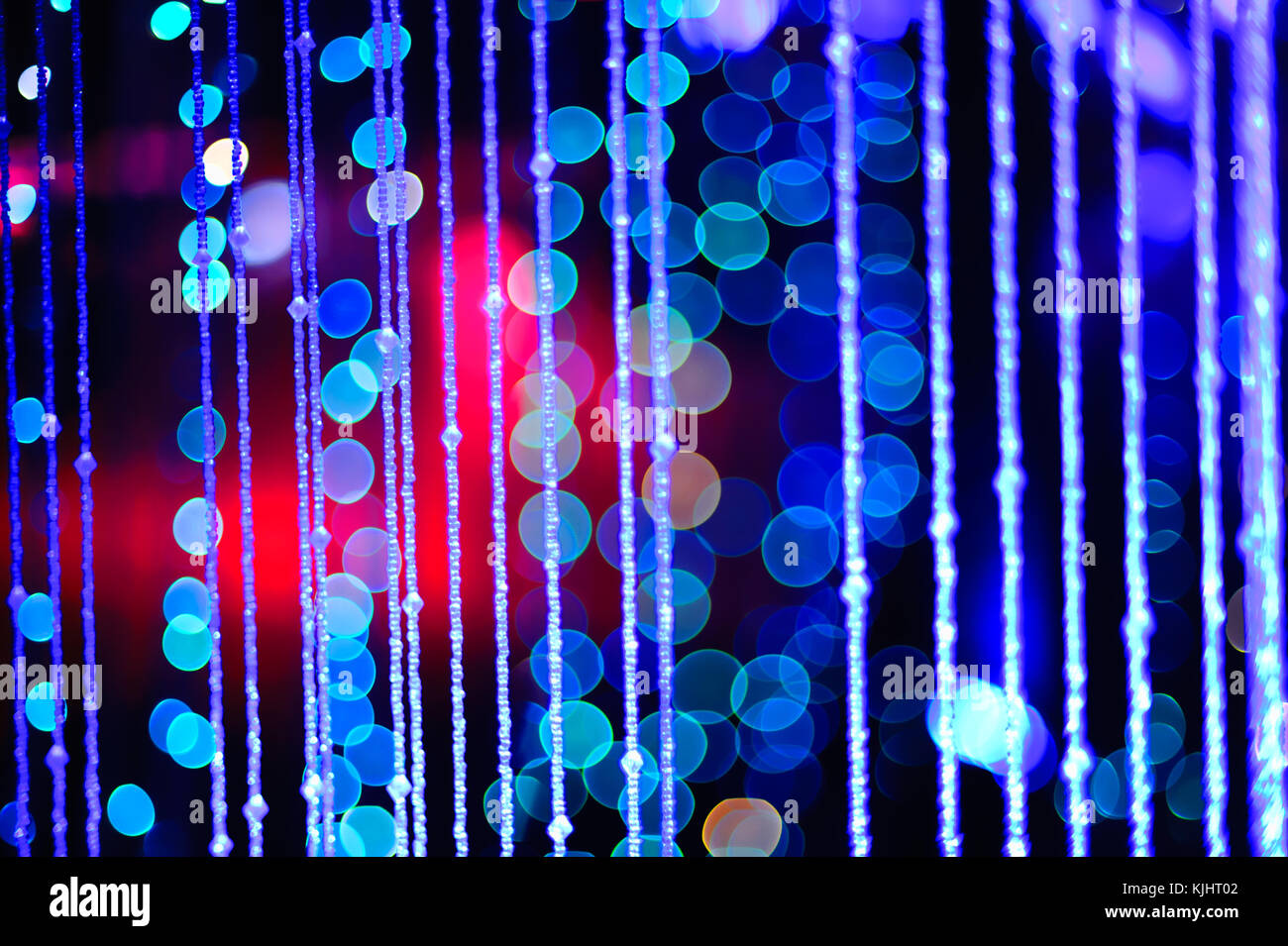 Curtain of strings / chains in blue colour with blue party lights with ...