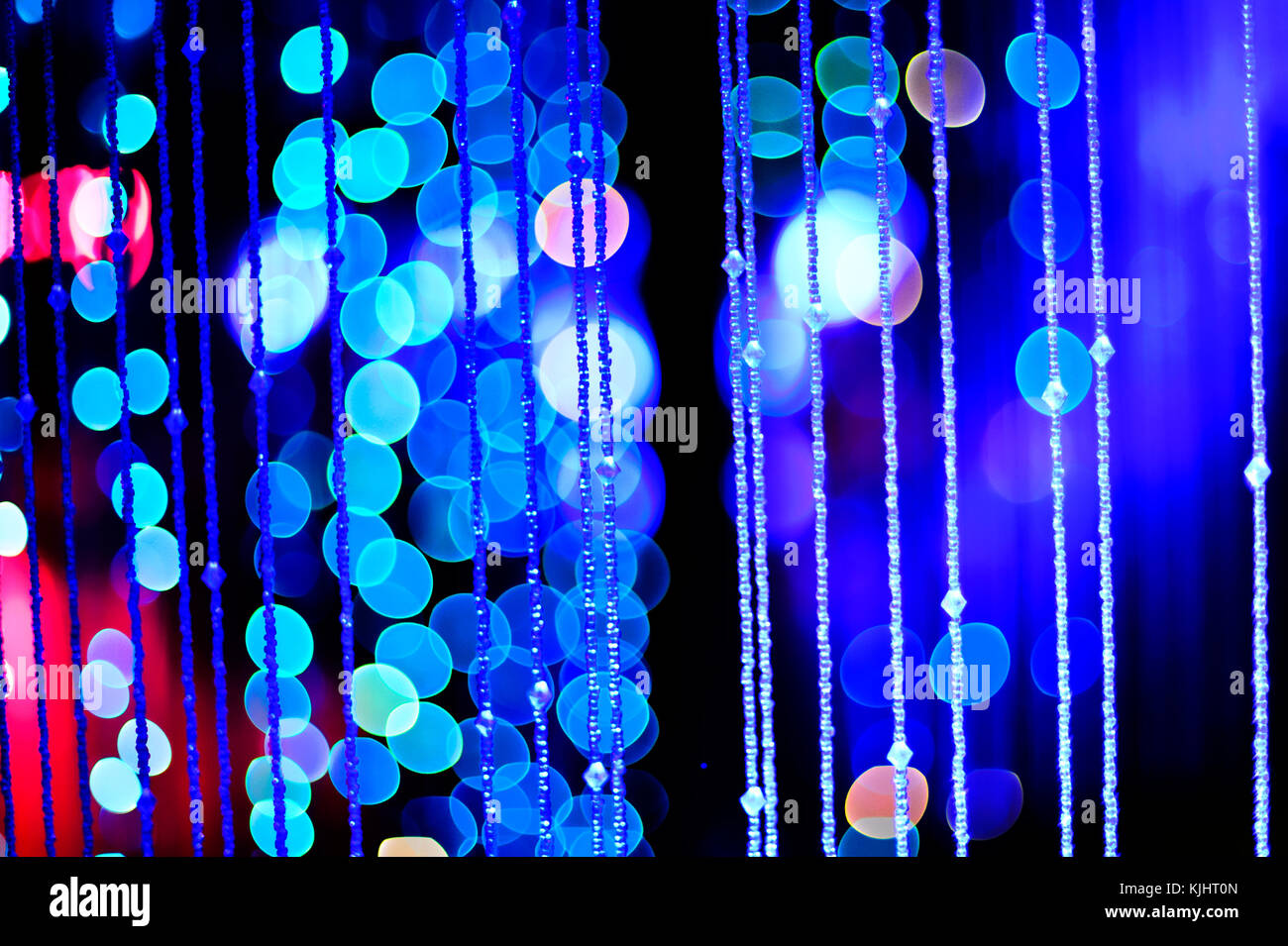 Curtain of strings / chains in blue colour with blue party lights with ...
