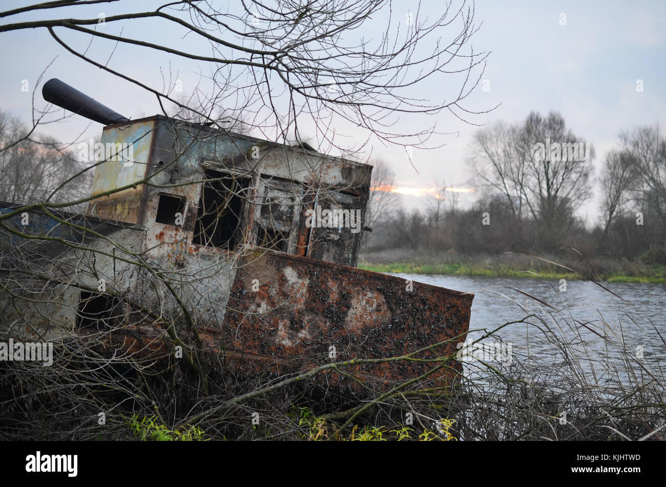 A dilapidated barge moored on the river bank Stock Photo - Alamy