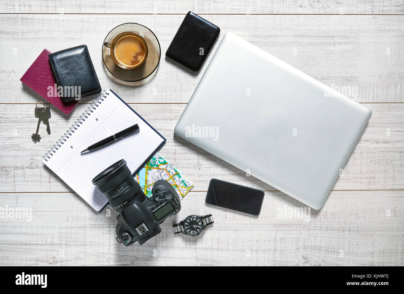 View of a wooden table with a laptop, external hdd, mobile, notebook ...