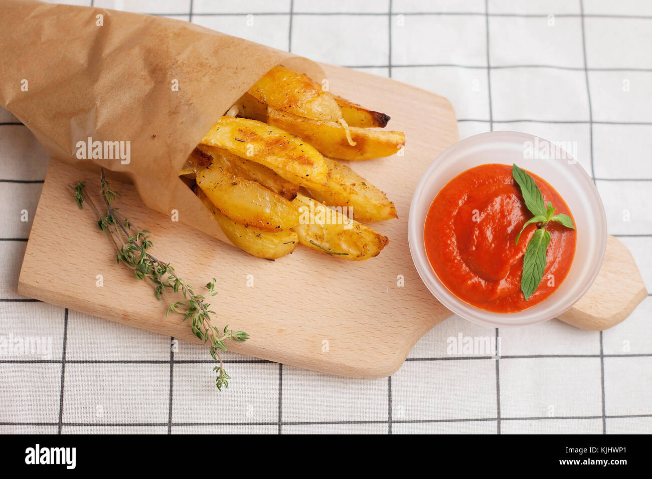 Roasted potatoes with mixed herbs and tomato ketchup Stock Photo - Alamy