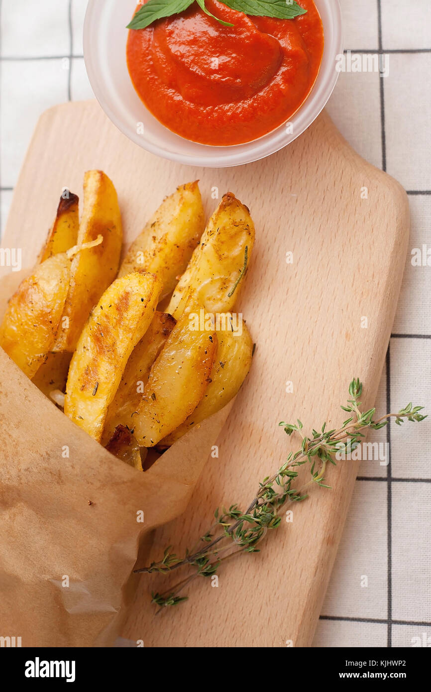 Roasted potatoes with mixed herbs and tomato ketchup Stock Photo - Alamy