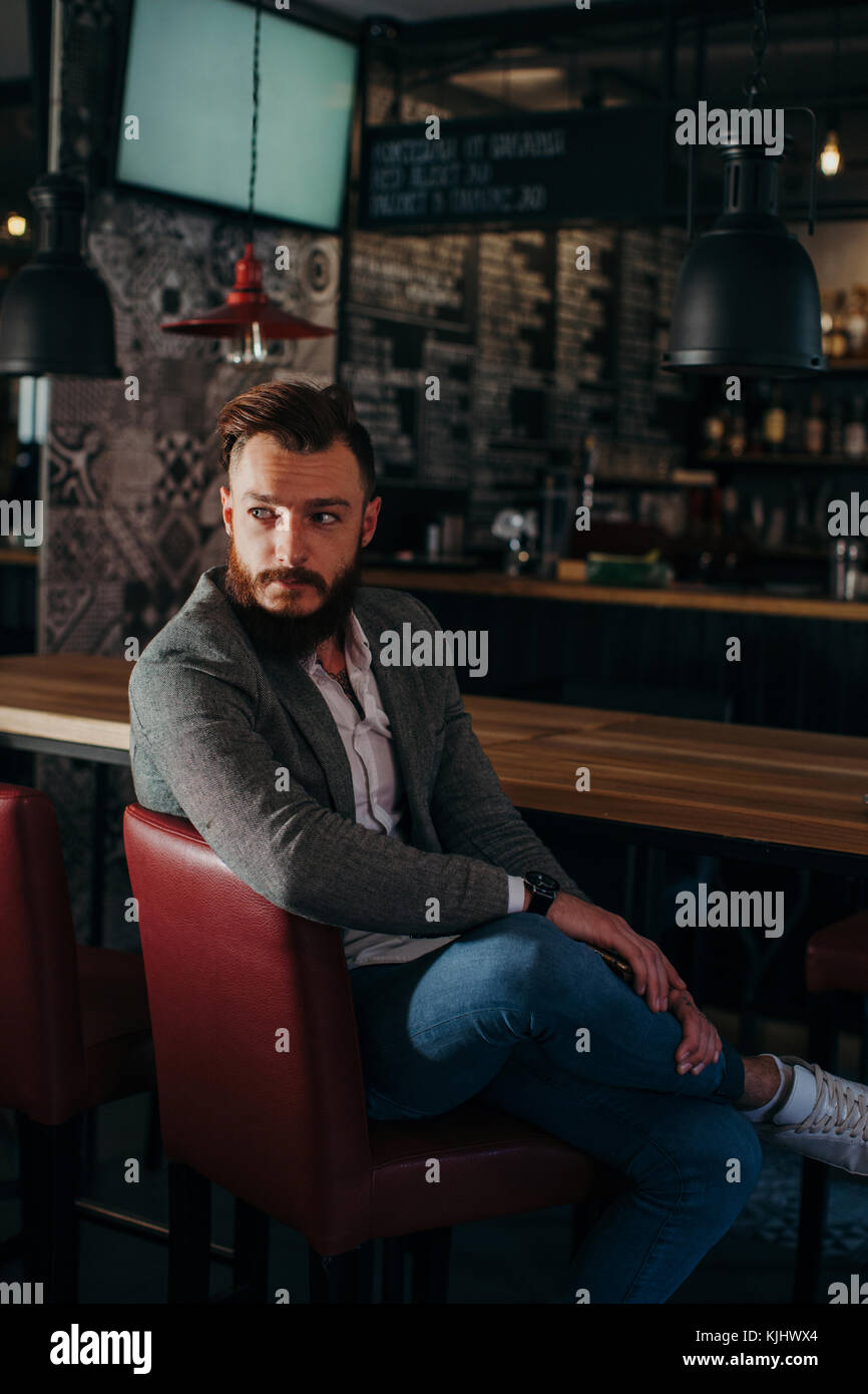 Portrait of a man sitting in a cafe Stock Photo - Alamy