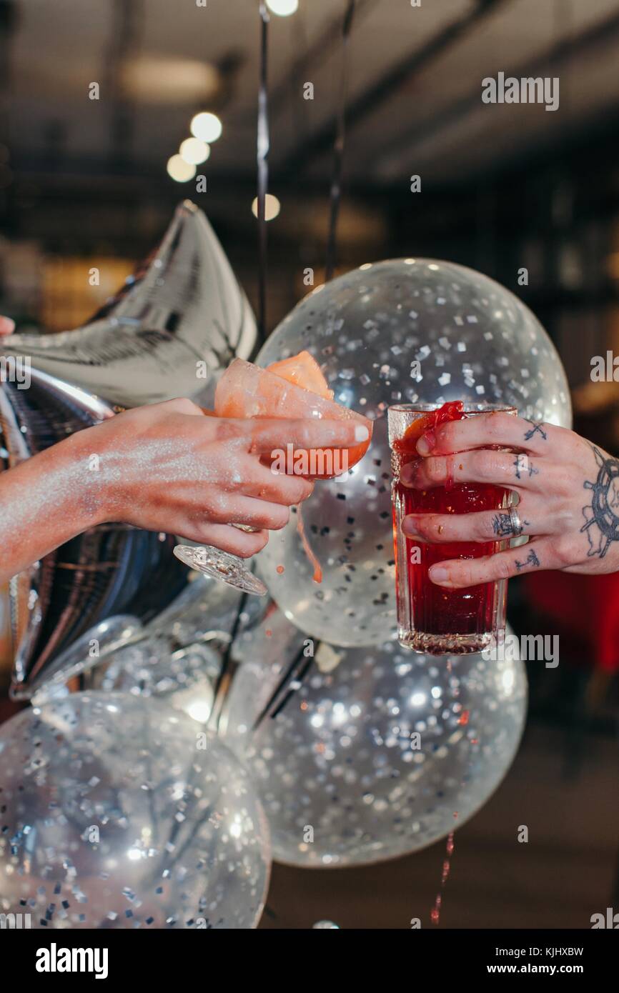 Man and woman in a bar making a celebratory toast Stock Photo - Alamy