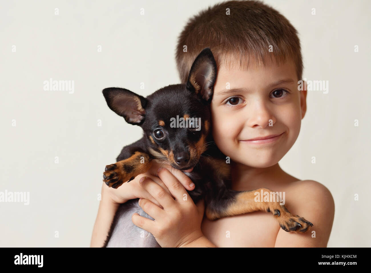 Boy holding a dog hi-res stock photography and images - Alamy