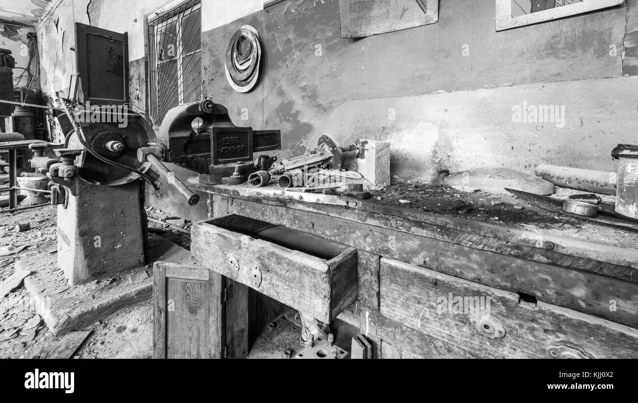 Old abandoned factory rooms, work table Stock Photo - Alamy