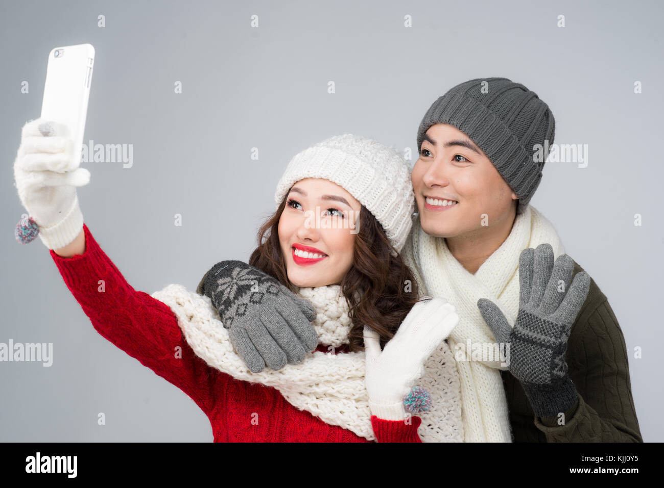 Happy young hipster couple hugging. Cold season. Taking selfie photo ...