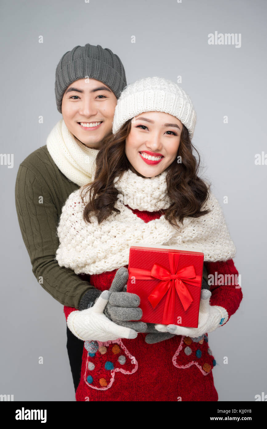 Romantic couple in a sweaters with gift box Stock Photo - Alamy
