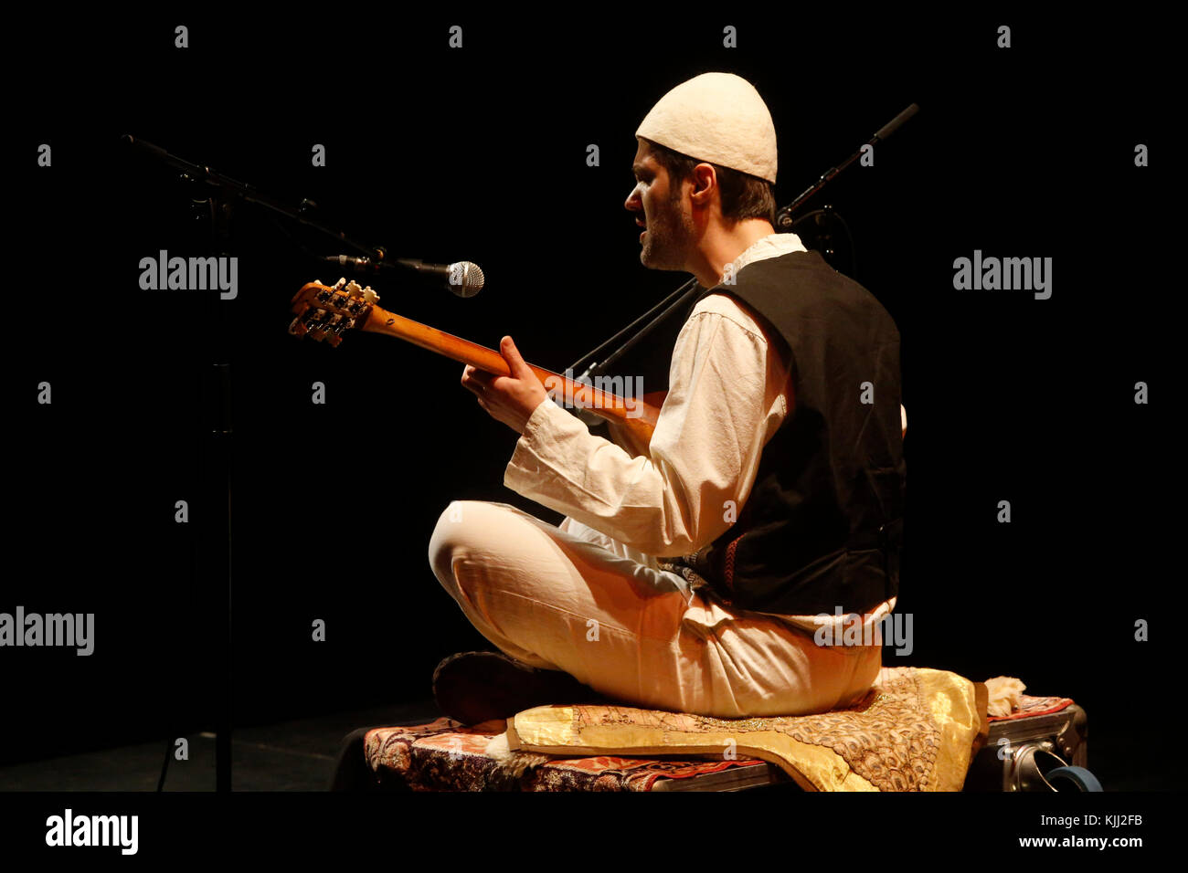 Albanian sufi musician Enris Qinami playing the sharki on stage. France ...