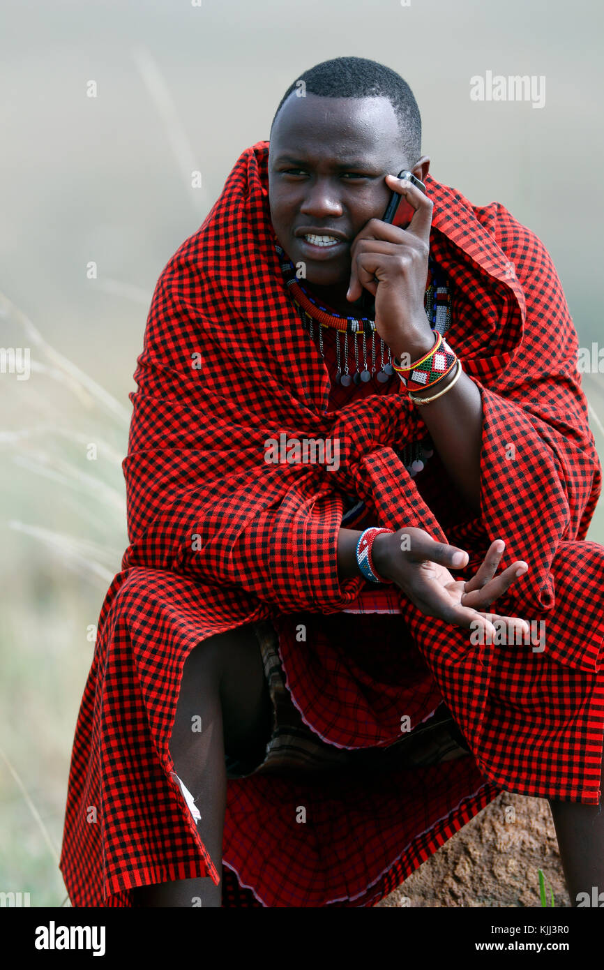 A Masai man talking on a mobile phone in the african savanna. Masai ...