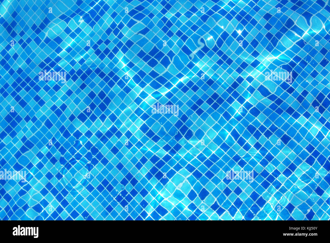 Sun reflection on the blue clear water ripples of swimming pool with ...