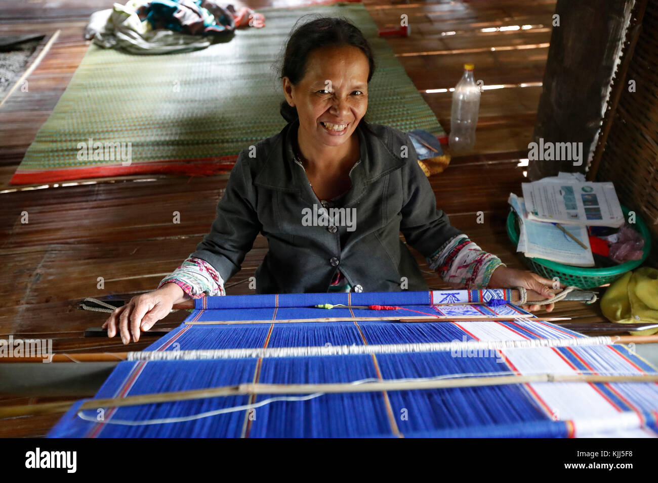 Bahnar (Ba Na) ethnic group. Woman weaving silk at wooden loom. Kon Tum ...