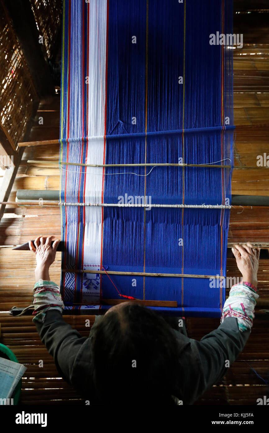 Bahnar (Ba Na) ethnic group. Woman weaving silk at wooden loom. Kon Tum ...