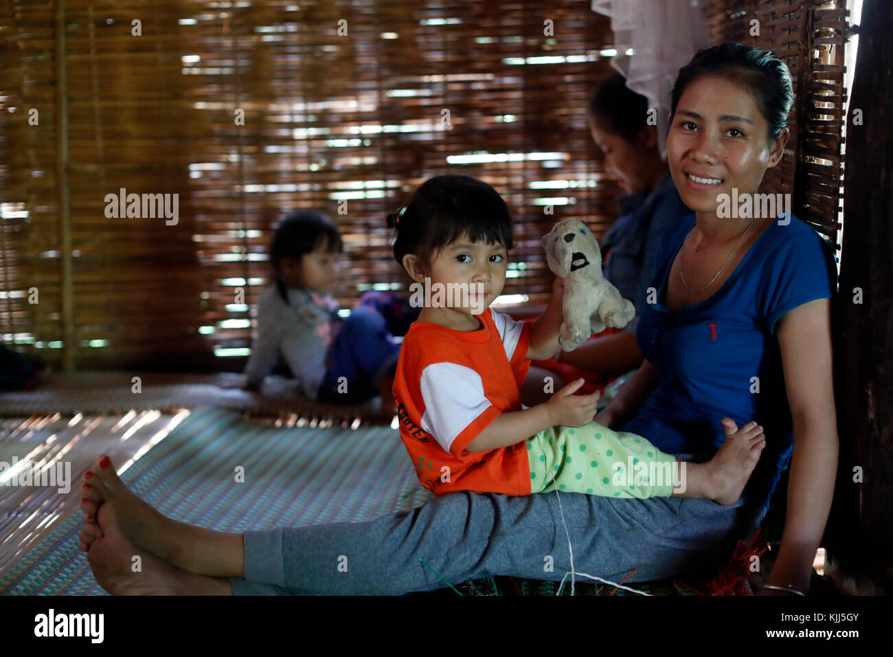 Bahnar (Ba Na) ethnic group. A woman and her daughter inside their ...