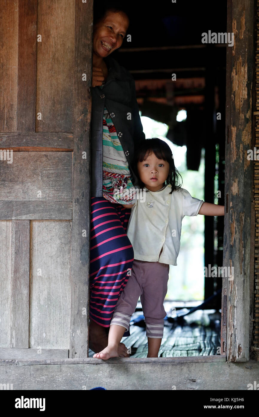 Bahnar (Ba Na) ethnic group. A smiling woman and her daughter inside ...