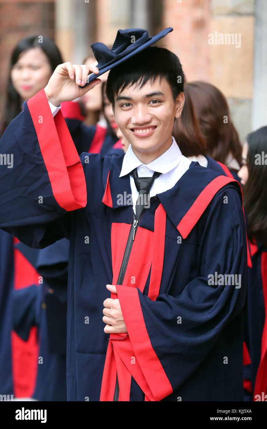 Group of Young Asian university students wearing cap and gown. Ho Chi ...