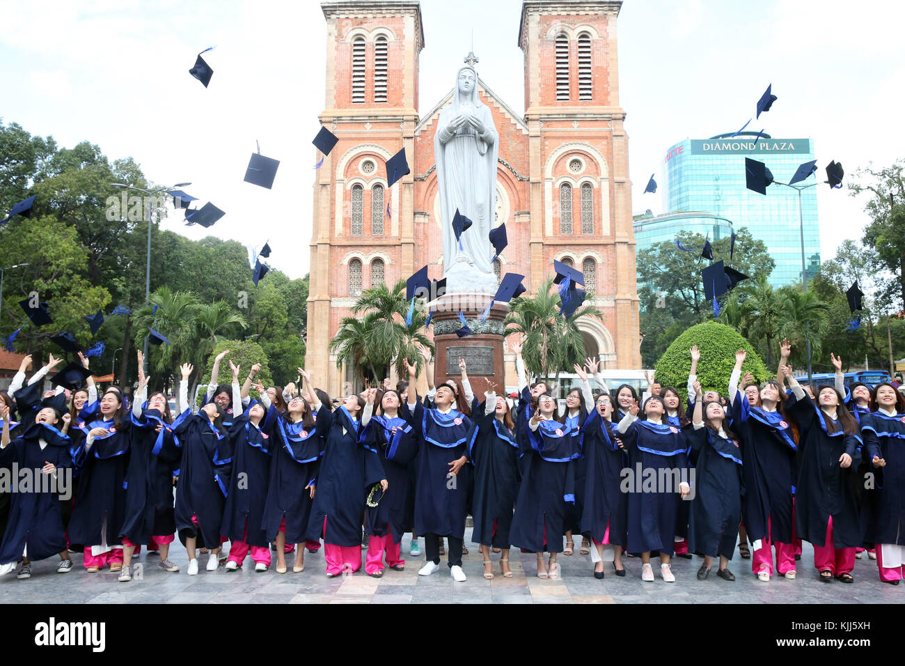 Group of Young Asian university students wearing cap and gown. Ho Chi ...