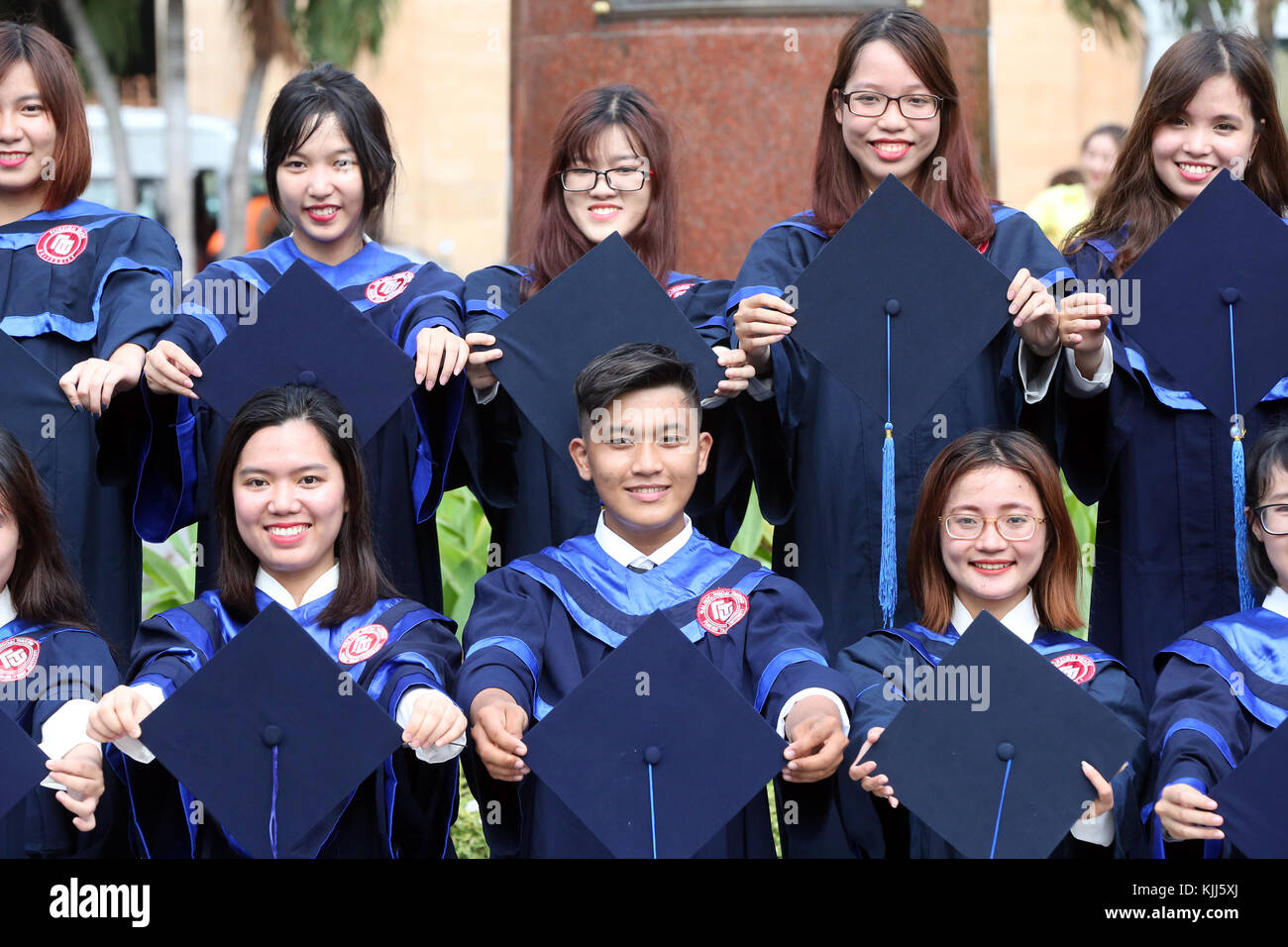 Group of Young Asian university students wearing cap and gown. Ho Chi ...