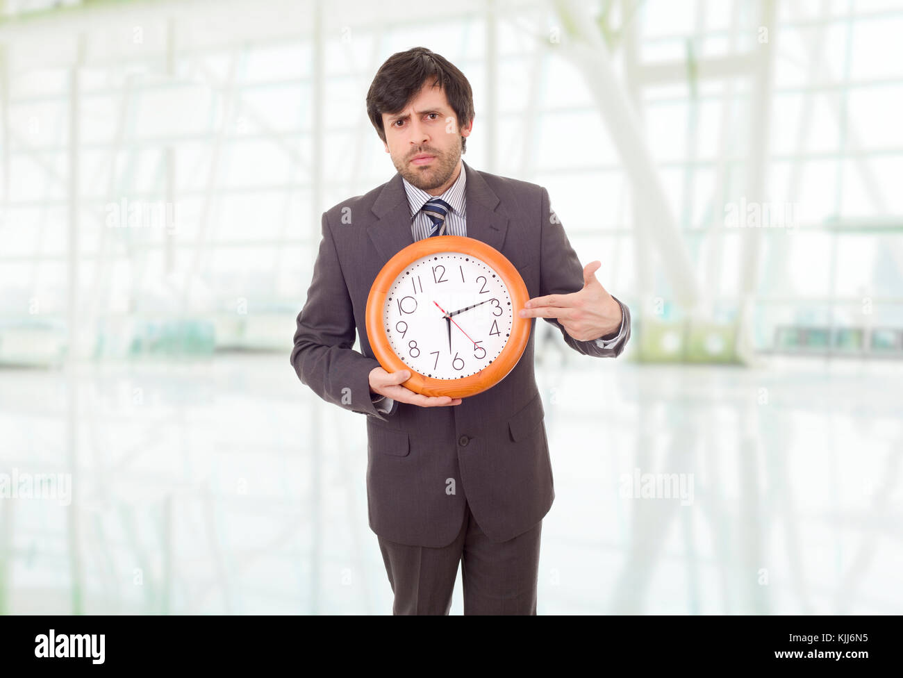 mad businessman with clock at the office Stock Photo - Alamy