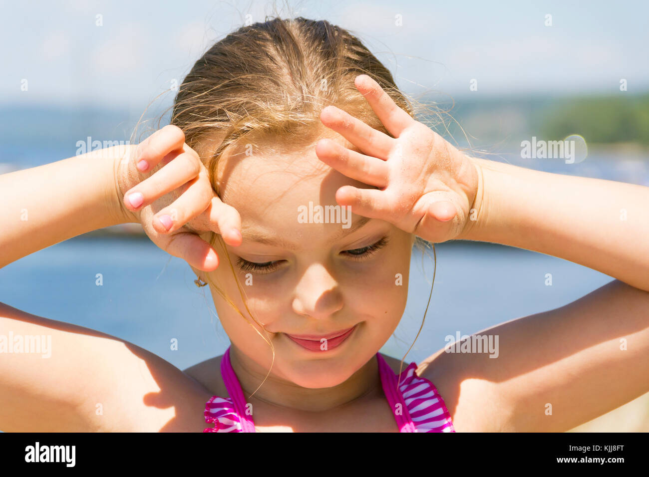 Photo of cute girl squint on the Sun Stock Photo - Alamy