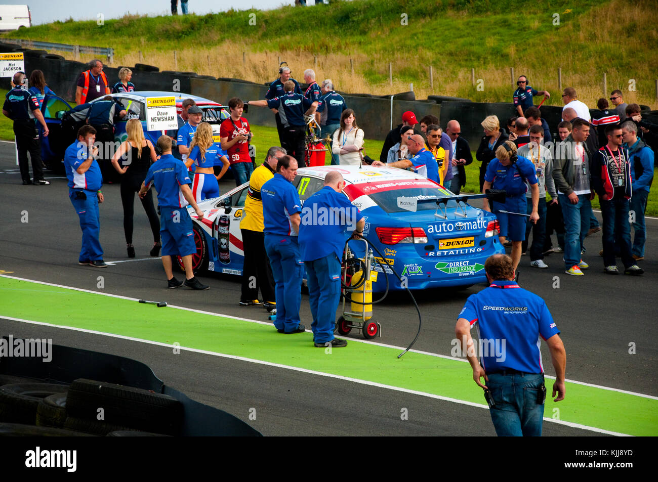 Mechanics and members of the racing fraternity gather at the start of a ...