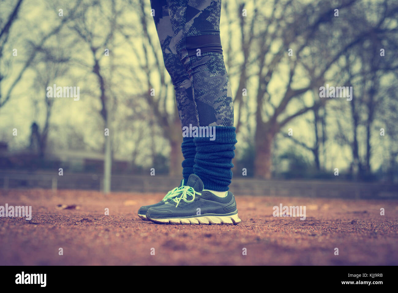 Runner legs on red running track at stadium or sports field Stock Photo ...