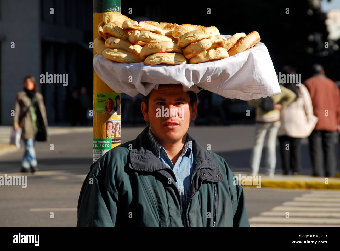 BUENOS AIRES, ARGENTINA - MAY 25, 2007: Man selling bread, carrying it ...