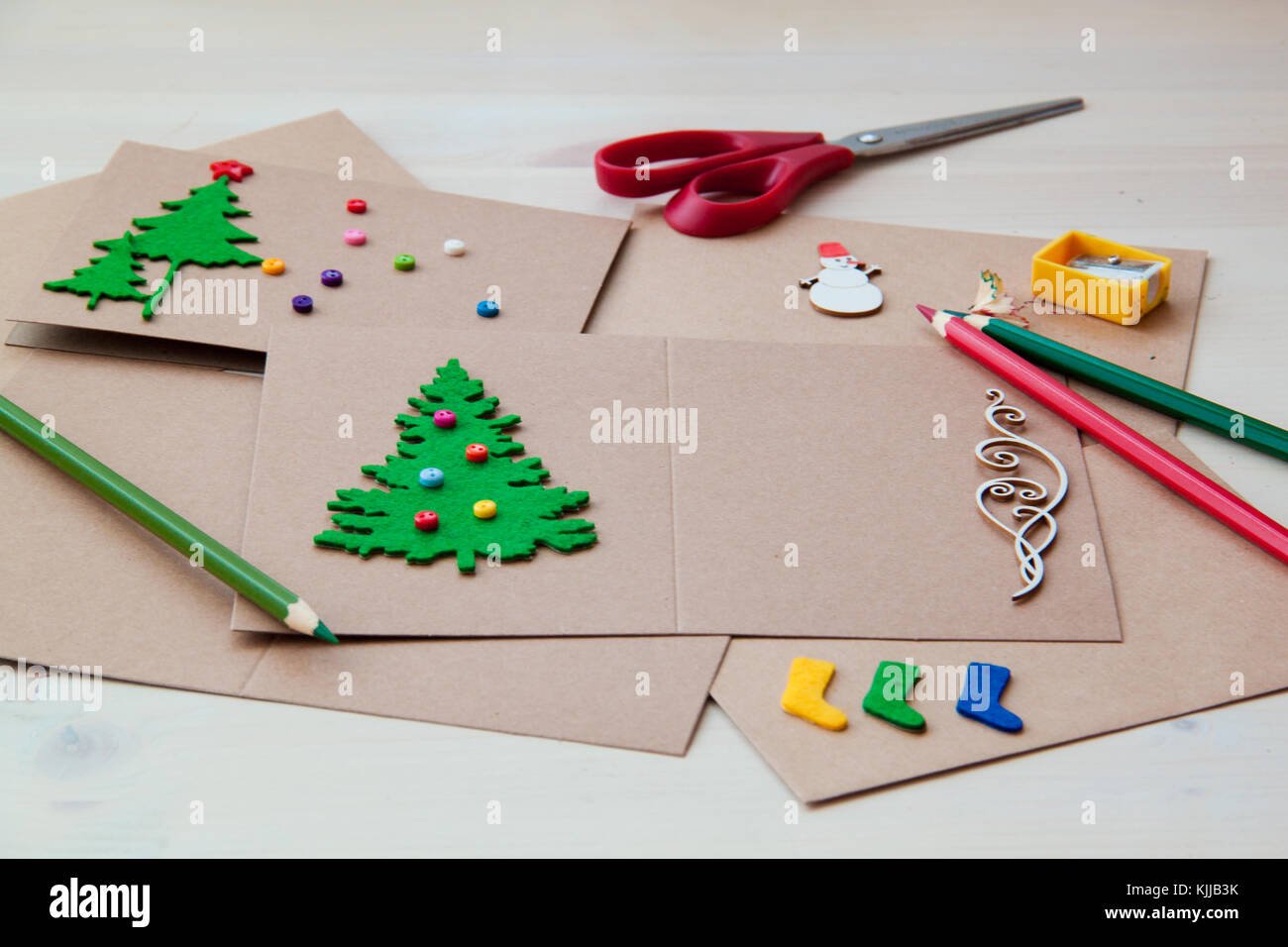 Signing Handmade Christmas cards. Felt, scissors, buttons, Christmas ...