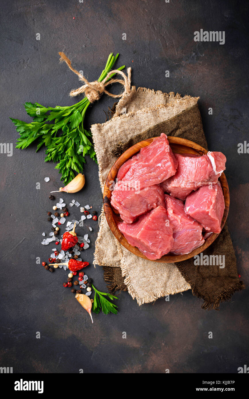 Raw chopped meat with spices on rusty background. Top view Stock Photo ...