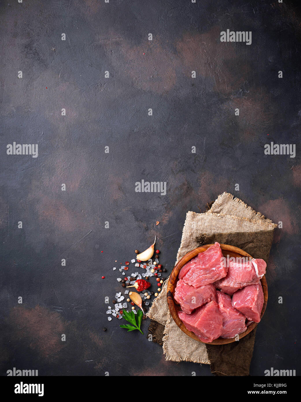 Raw chopped meat with spices on rusty background. Top view Stock Photo ...